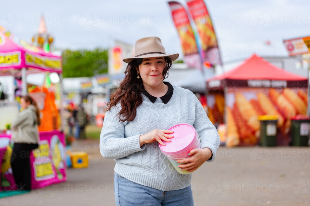 Image of Young lady at rural agricultural show holding bucket of fairy ...