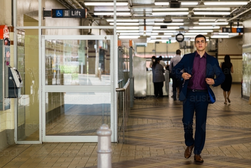 Image of young man at train station - Austockphoto