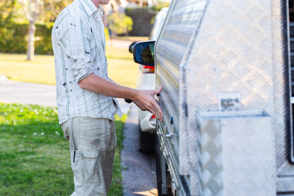 Image of young man closing side of tradie handyman ute - Austockphoto