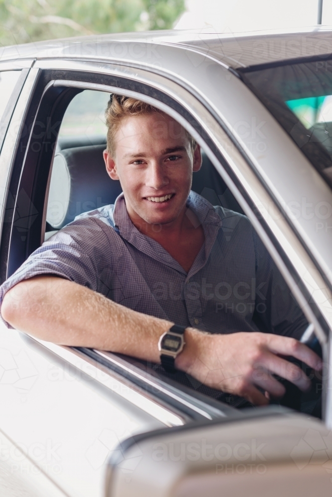 Image of young man in a car - Austockphoto