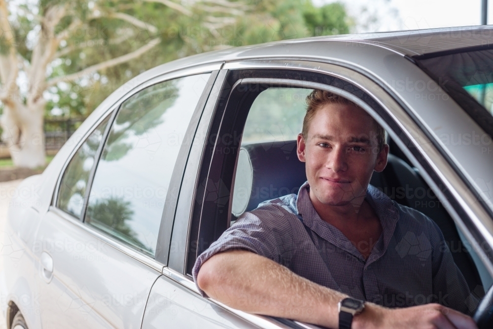 Image of young man in a car - Austockphoto