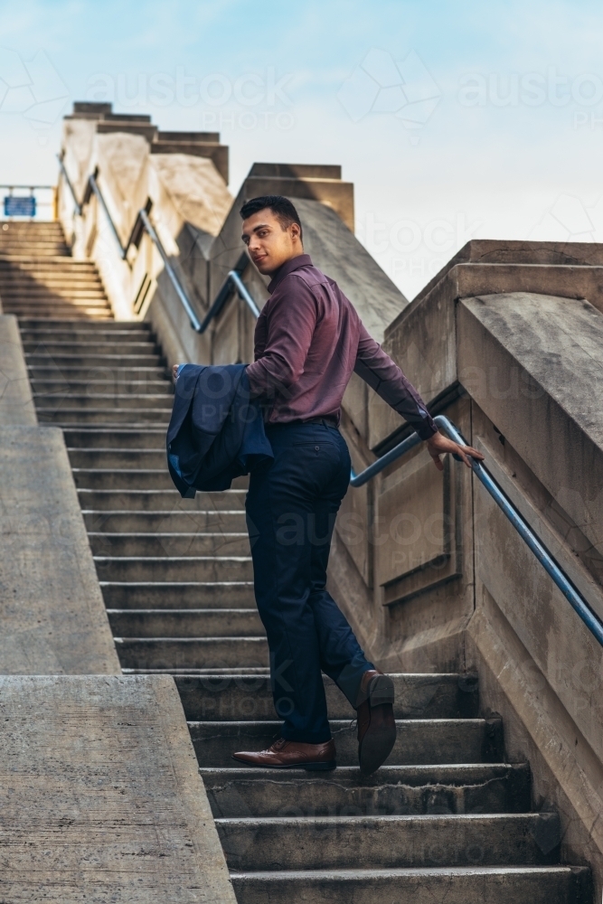 Image of young man on stairs - Austockphoto