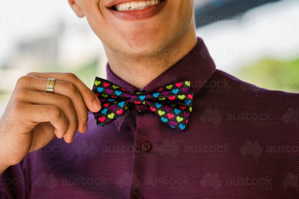 Image of young man wearing fun bow tie - Austockphoto