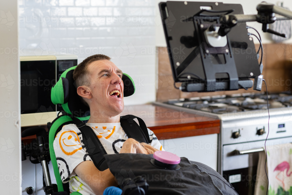 Image of Young man with disability on his wheelchair smiling at ...