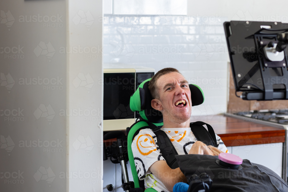 Image of Young man with disability on his wheelchair smiling while ...