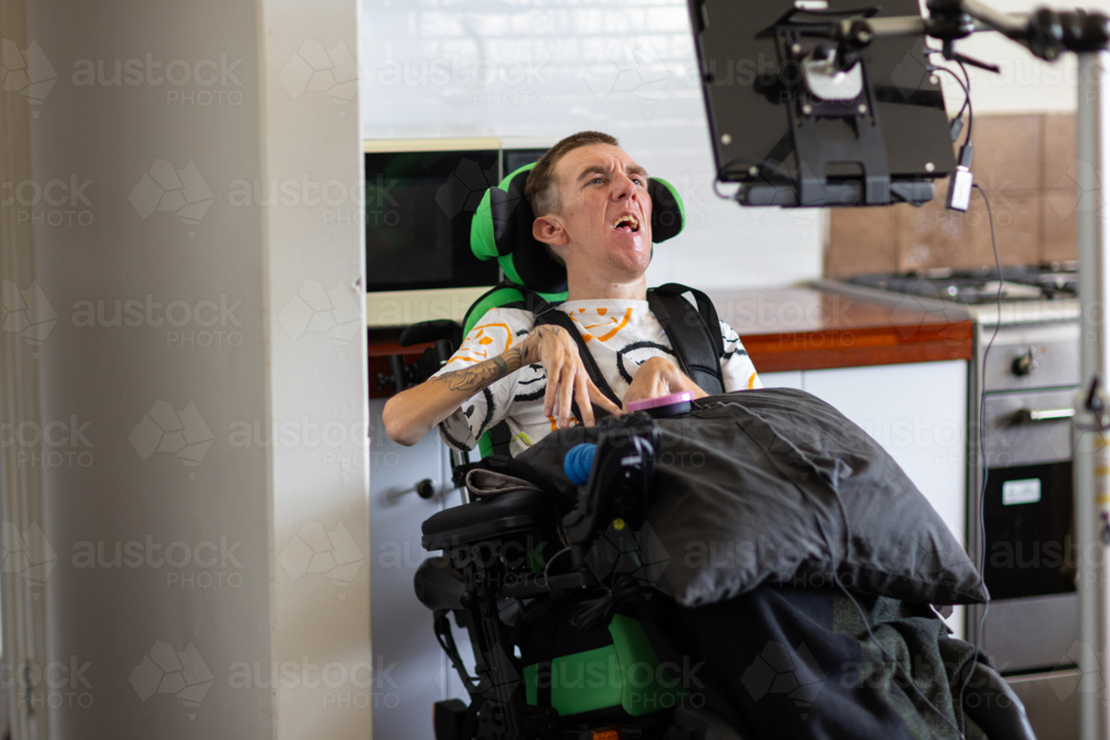 Image of Young man with disability on his wheelchair using technology ...