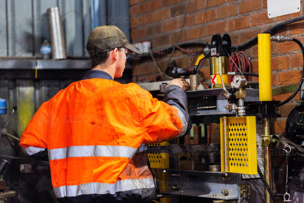 Image of young mechanic tradie using workshop mate press tool ...
