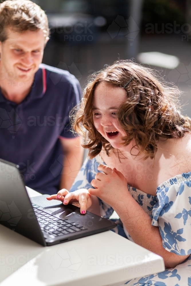 Image of Young person who has down syndrome working with her disability ...