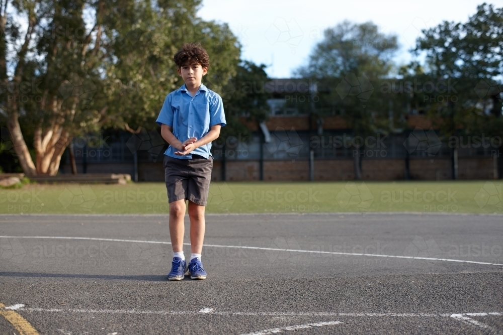 Image of Young school boy at school grounds - Austockphoto