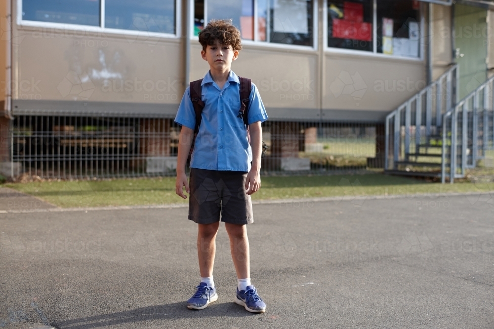 Image of Young school boy in front of demountable classroom - Austockphoto