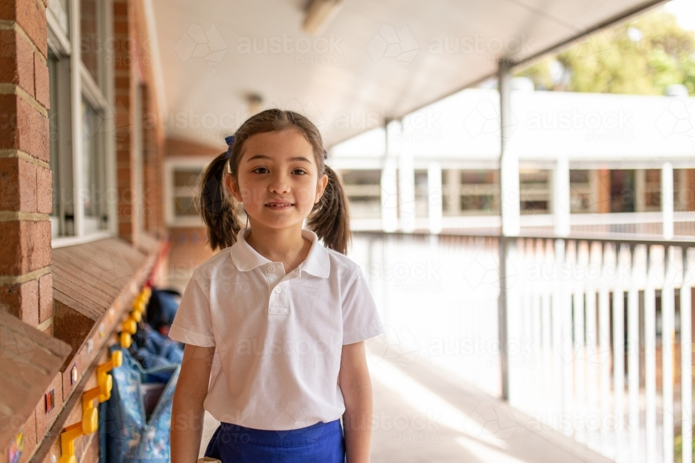 Image of Young Schoolgirl standing along the school balcony - Austockphoto