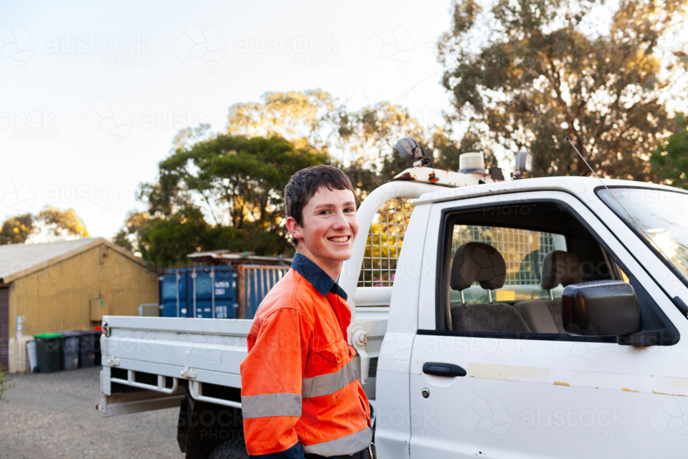 Image of Young Teenaged Australian with ute on farm wearing high-vis ...