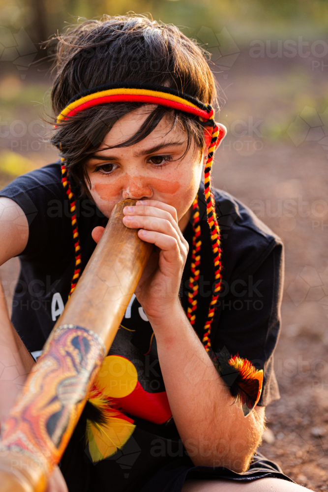 Image of Young tween Aboriginal boy outside in rural Australia playing ...