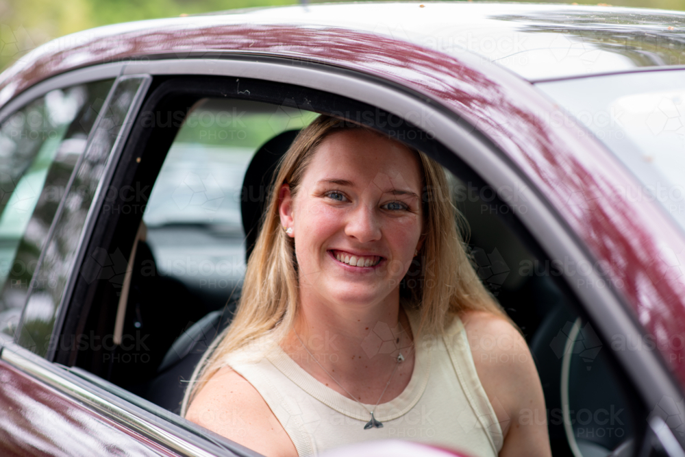 Image of young woman driver in her car - Austockphoto