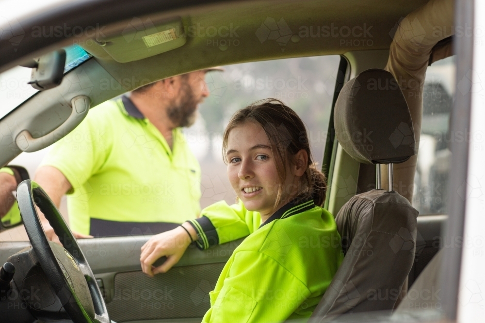 Image of Young woman in vehicle wearing hi-vis - Austockphoto