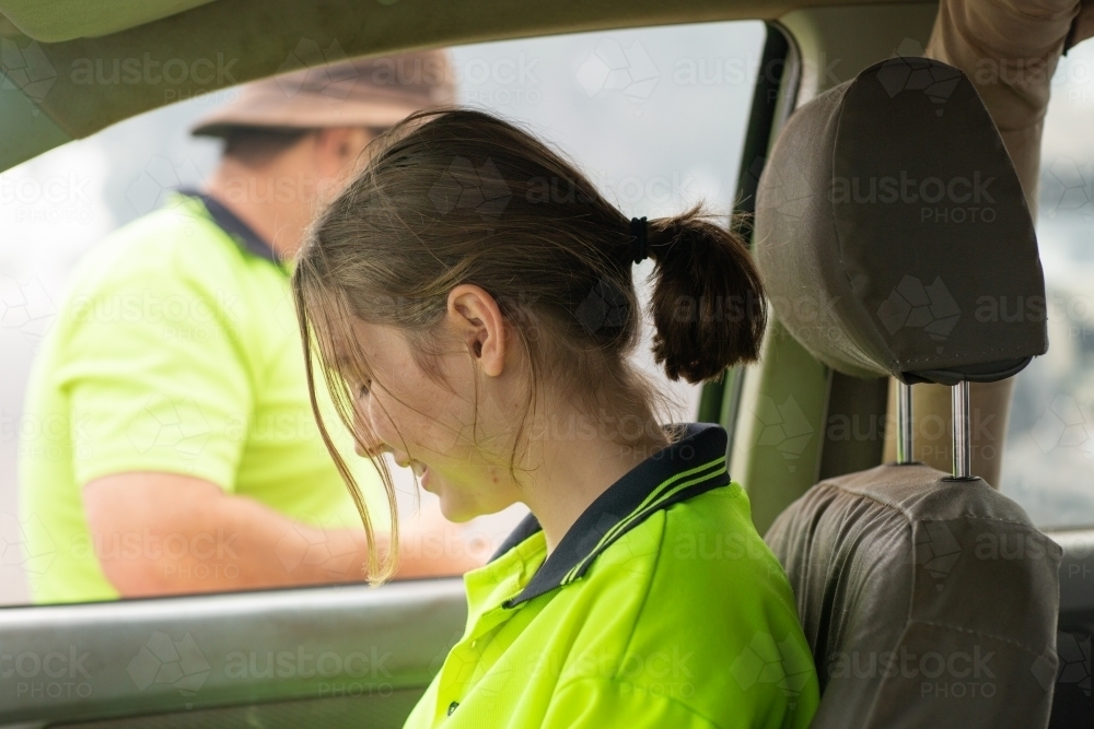 Image of Young woman in vehicle wearing hi-vis - Austockphoto