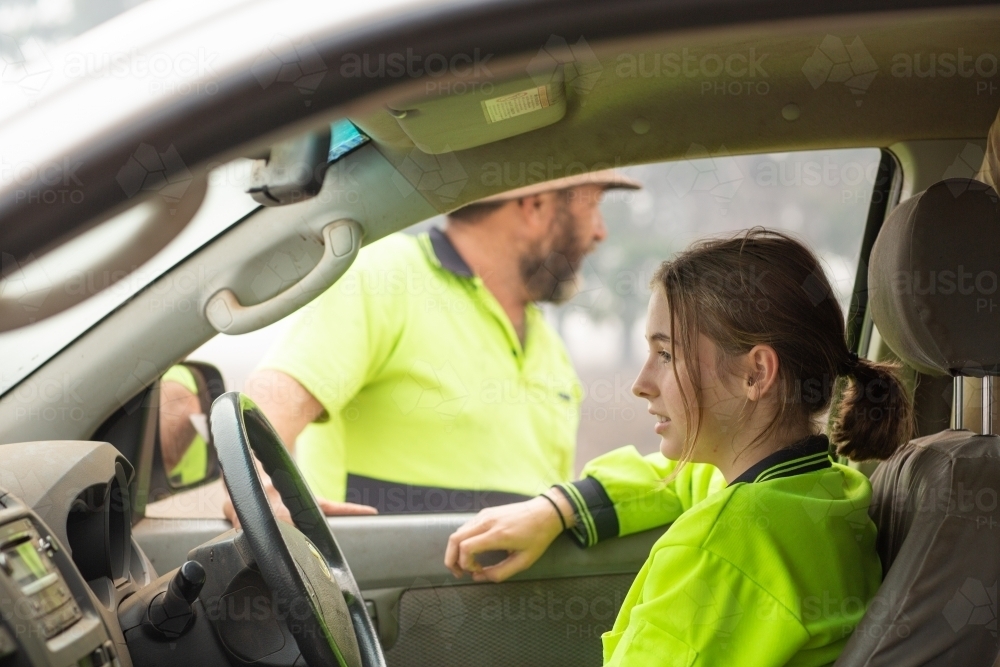 Image of Young woman in vehicle wearing hi-vis - Austockphoto