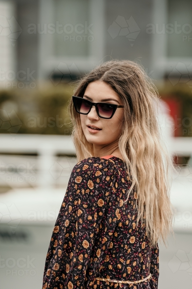Image of Young woman looking back. - Austockphoto
