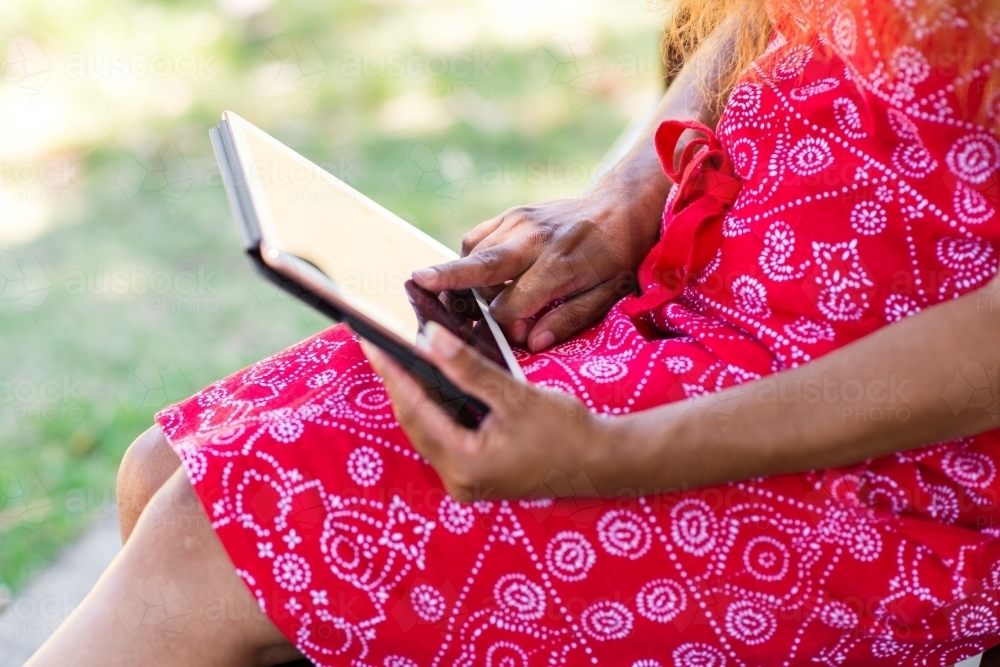 Image of young woman using ipad - Austockphoto