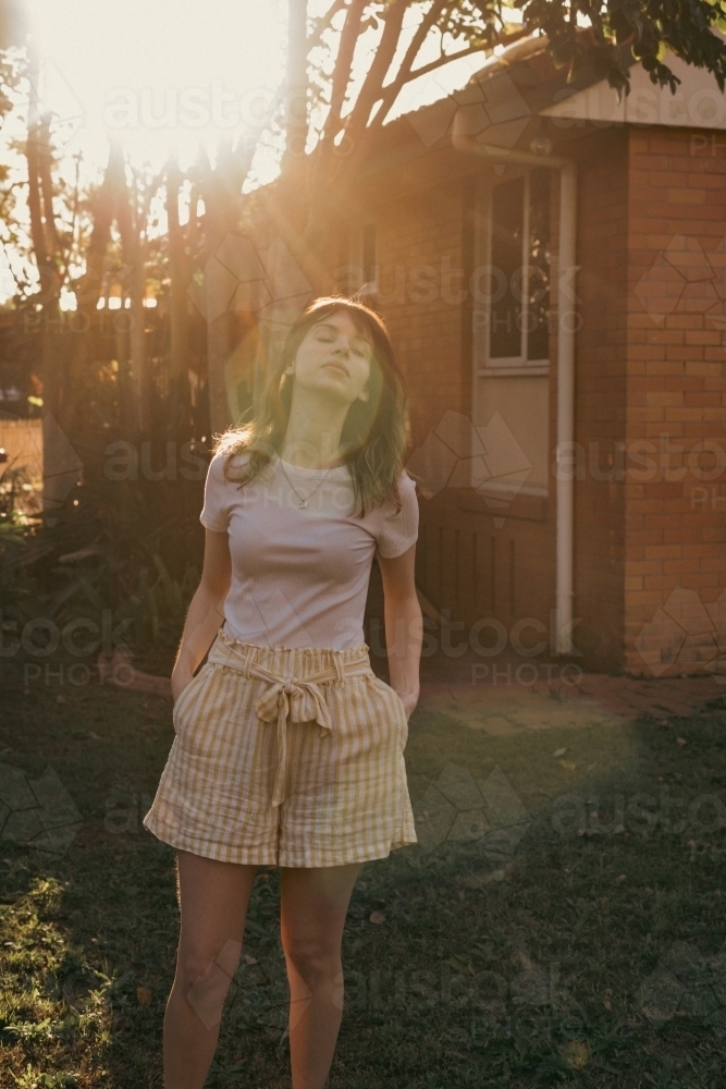 Image of young woman with sun flare, ugc style - Austockphoto
