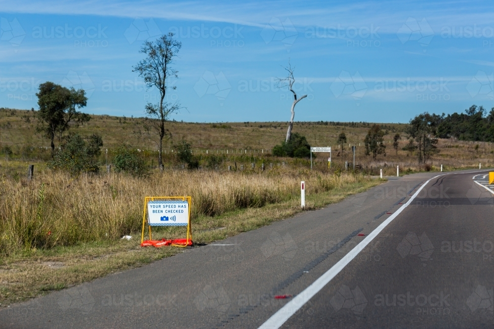 Image of Your speed has been checked sign beside highway road ...