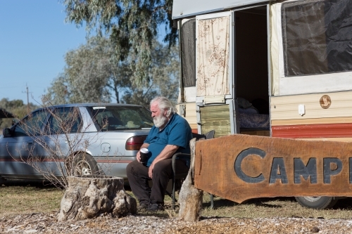 Young man wearing cowboy hat in the outback